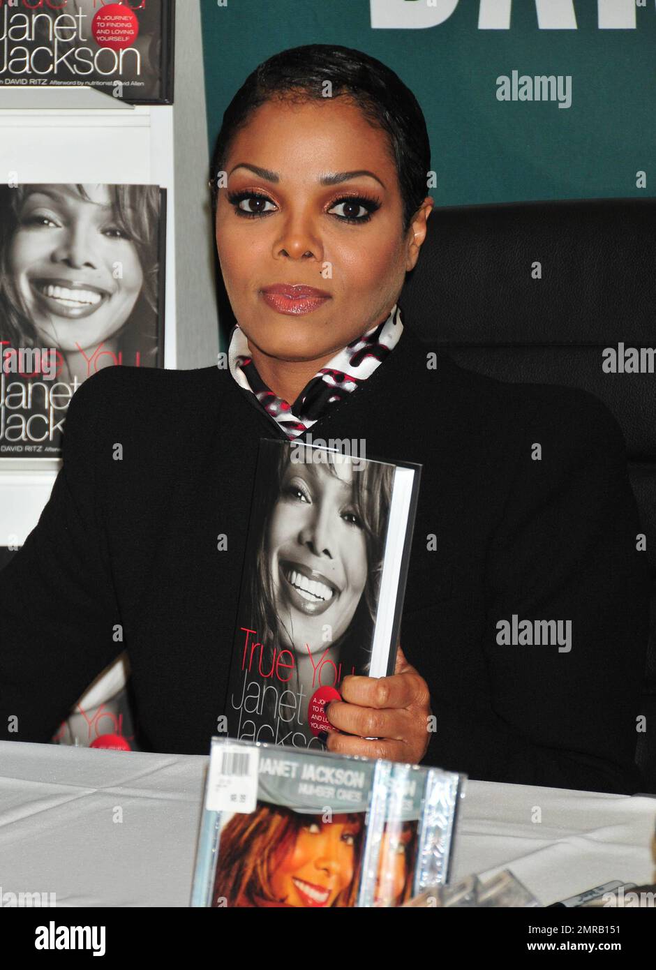 Singer Janet Jackson shows off her short slicked back hair and wears a ...