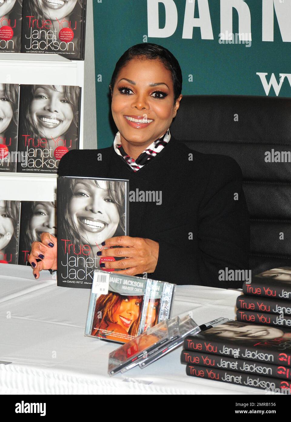 Singer Janet Jackson shows off her short slicked back hair and wears a ...