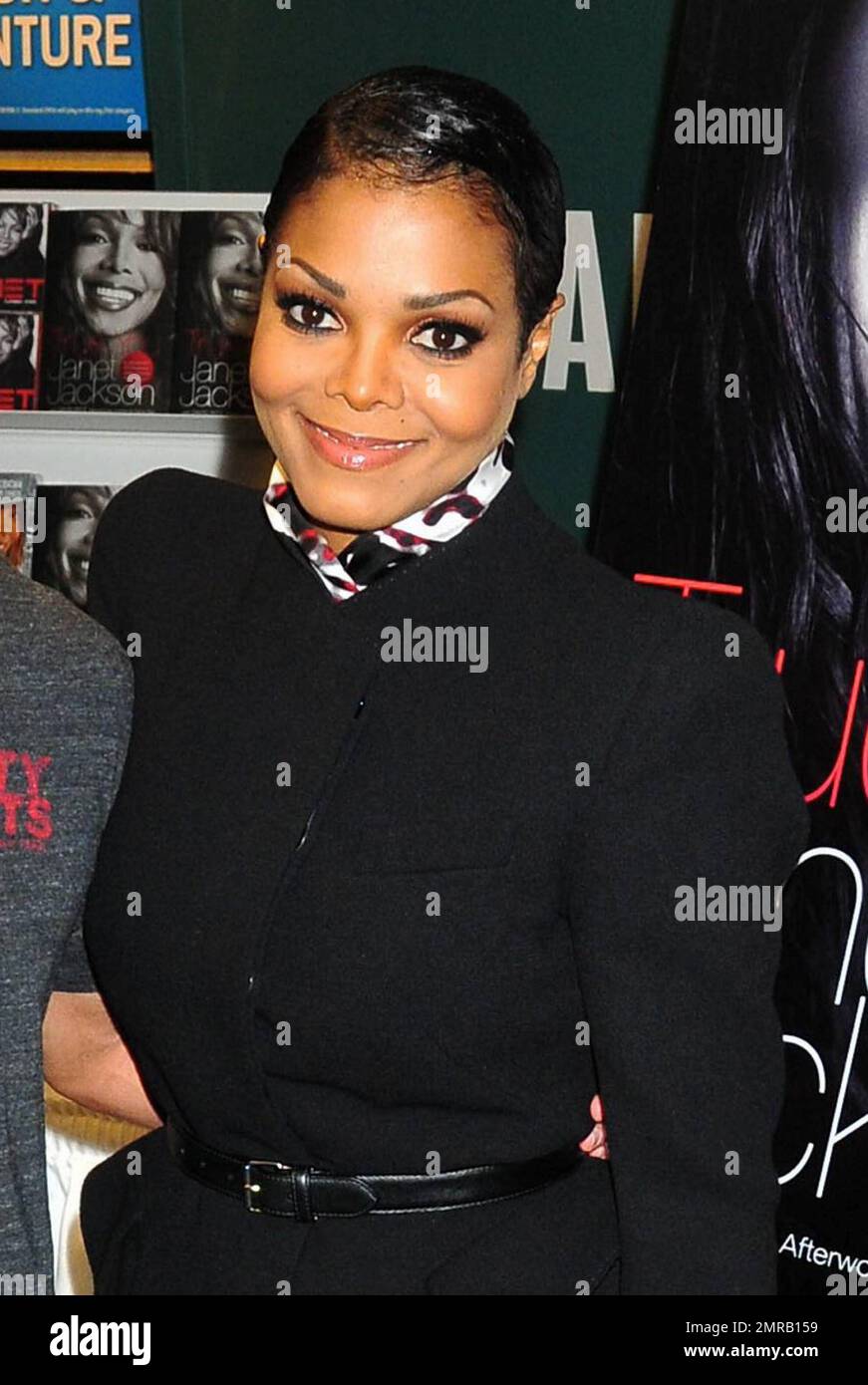 Singer Janet Jackson shows off her short slicked back hair and wears a ...