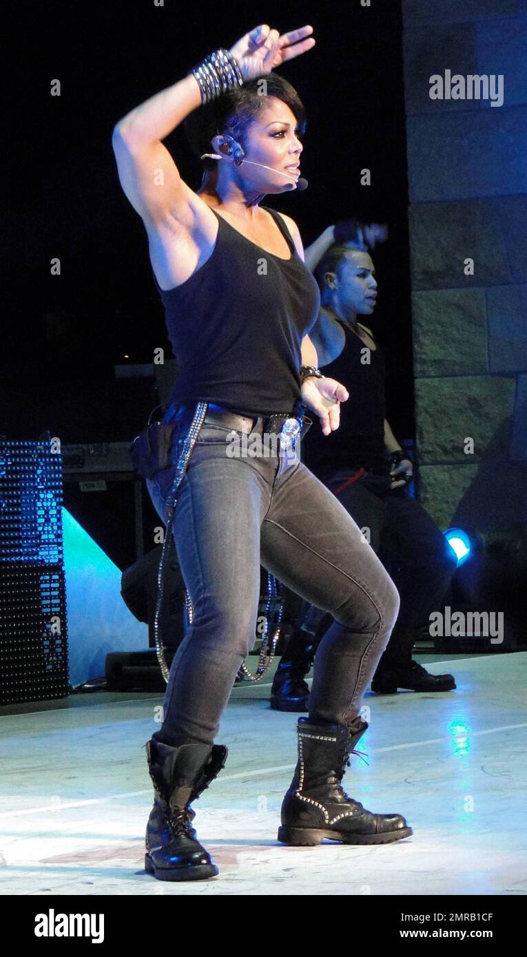 In tight grey jeans, a black tank top and white denim jacket paired ...