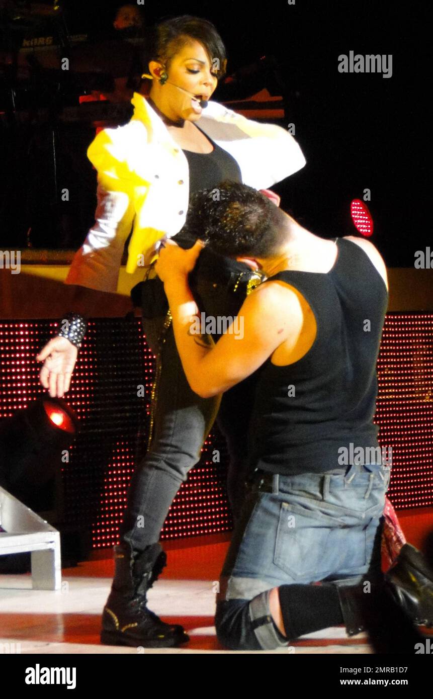 In tight grey jeans, a black tank top and white denim jacket paired ...