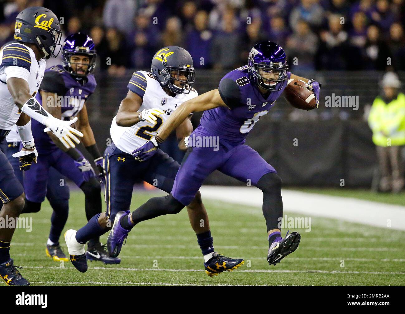 Washington's Dante Pettis, right, runs with the ball after a pass ...