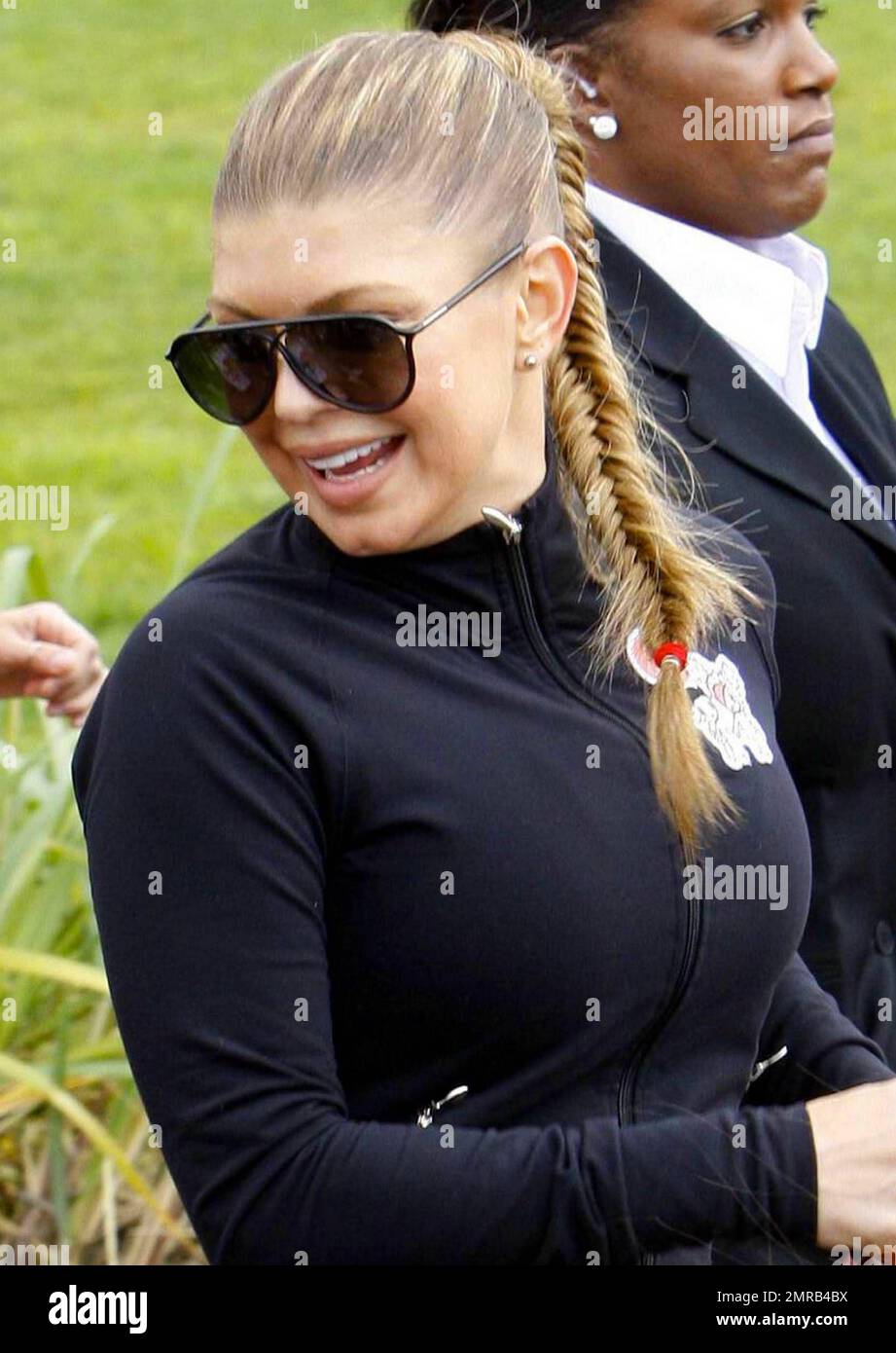 In tight black workout pants and a tight black jacket Fergie attends a ...