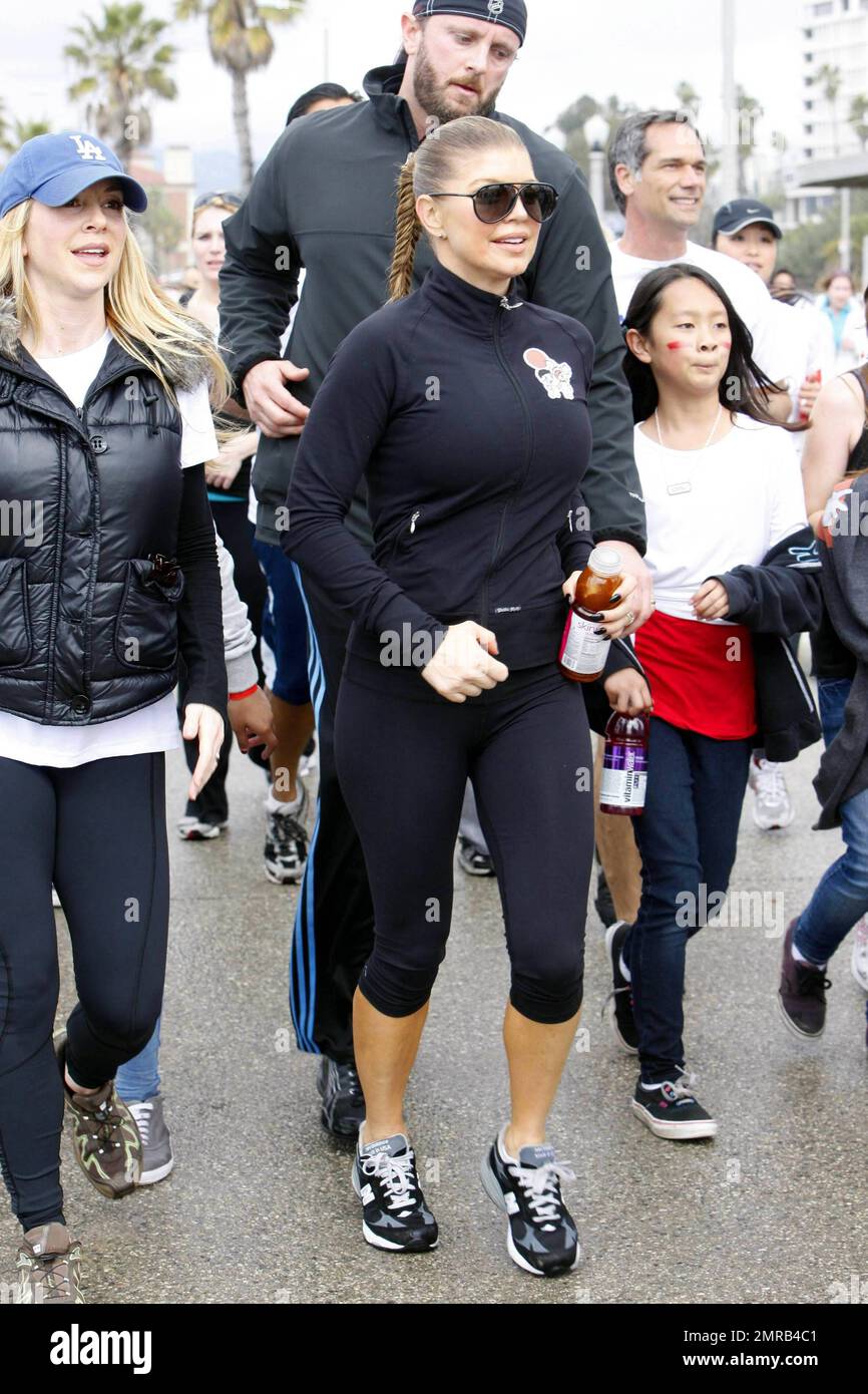 In tight black workout pants and a tight black jacket Fergie attends a ...