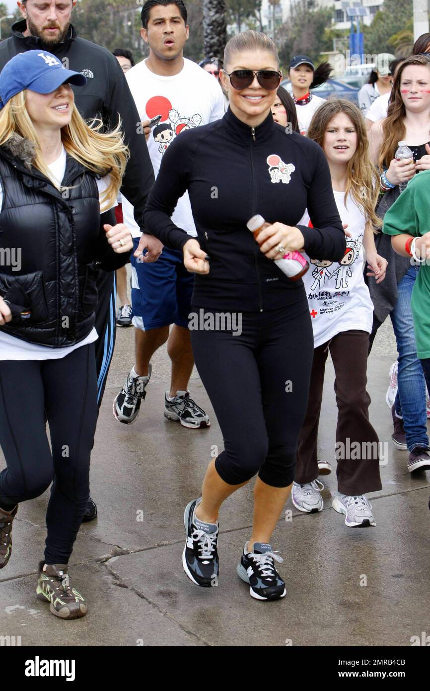 In tight black workout pants and a tight black jacket Fergie attends a ...