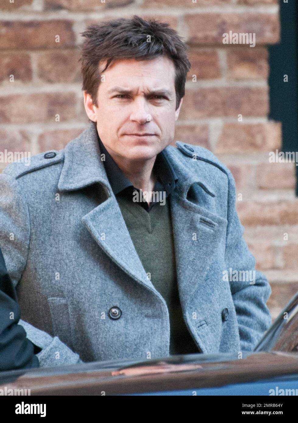 Actor Jason Bateman has a stern look on his face as he chats outside ...