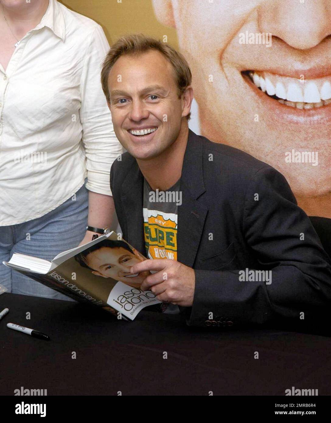 Pop singer and former "Neighbours" star Jason Donovan signs copies of ...
