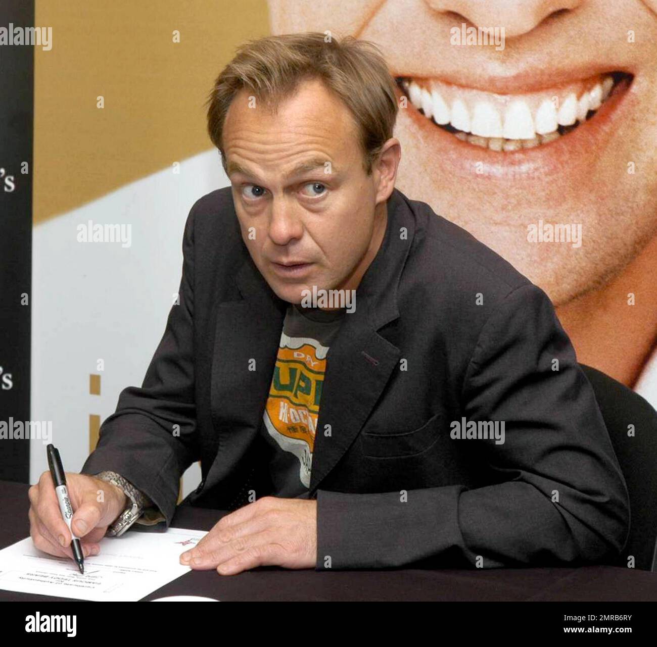 Pop singer and former "Neighbours" star Jason Donovan signs copies of ...