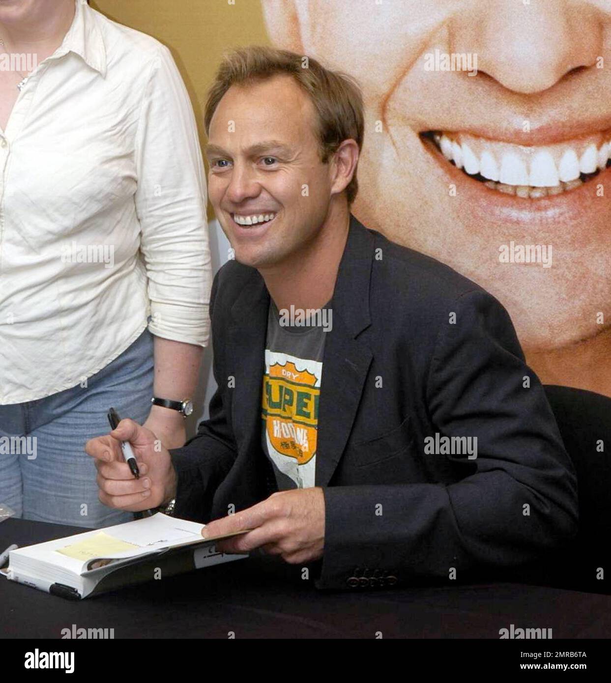 Pop singer and former "Neighbours" star Jason Donovan signs copies of ...
