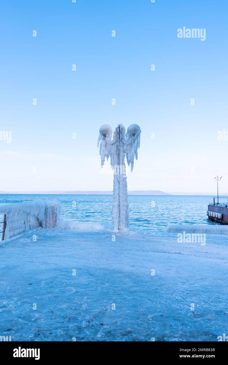 Frozen city after freezing rain. Vladivostok. The street lamp is frozen ...