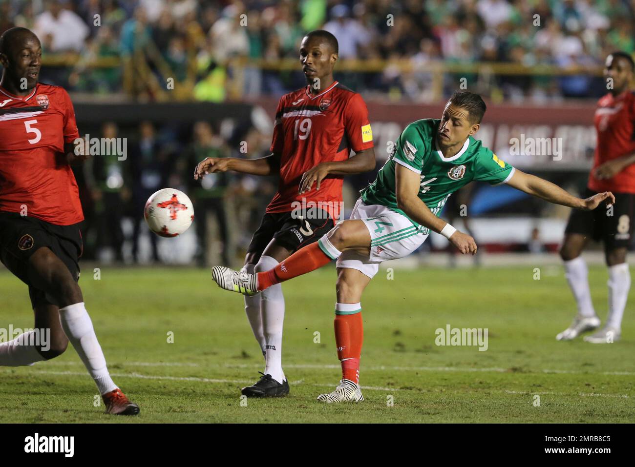 Mexico's Javier Hernandez (14) strikes the ball as Trinidad's Kevan ...