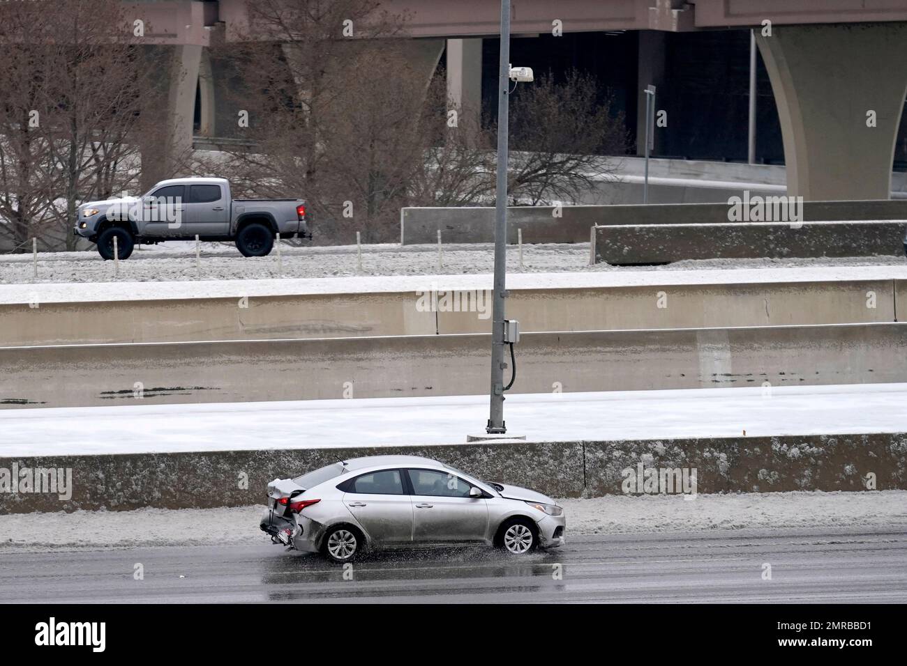 Drivers slowly navigate through icy road conditions on LBJ 635 Freeway ...