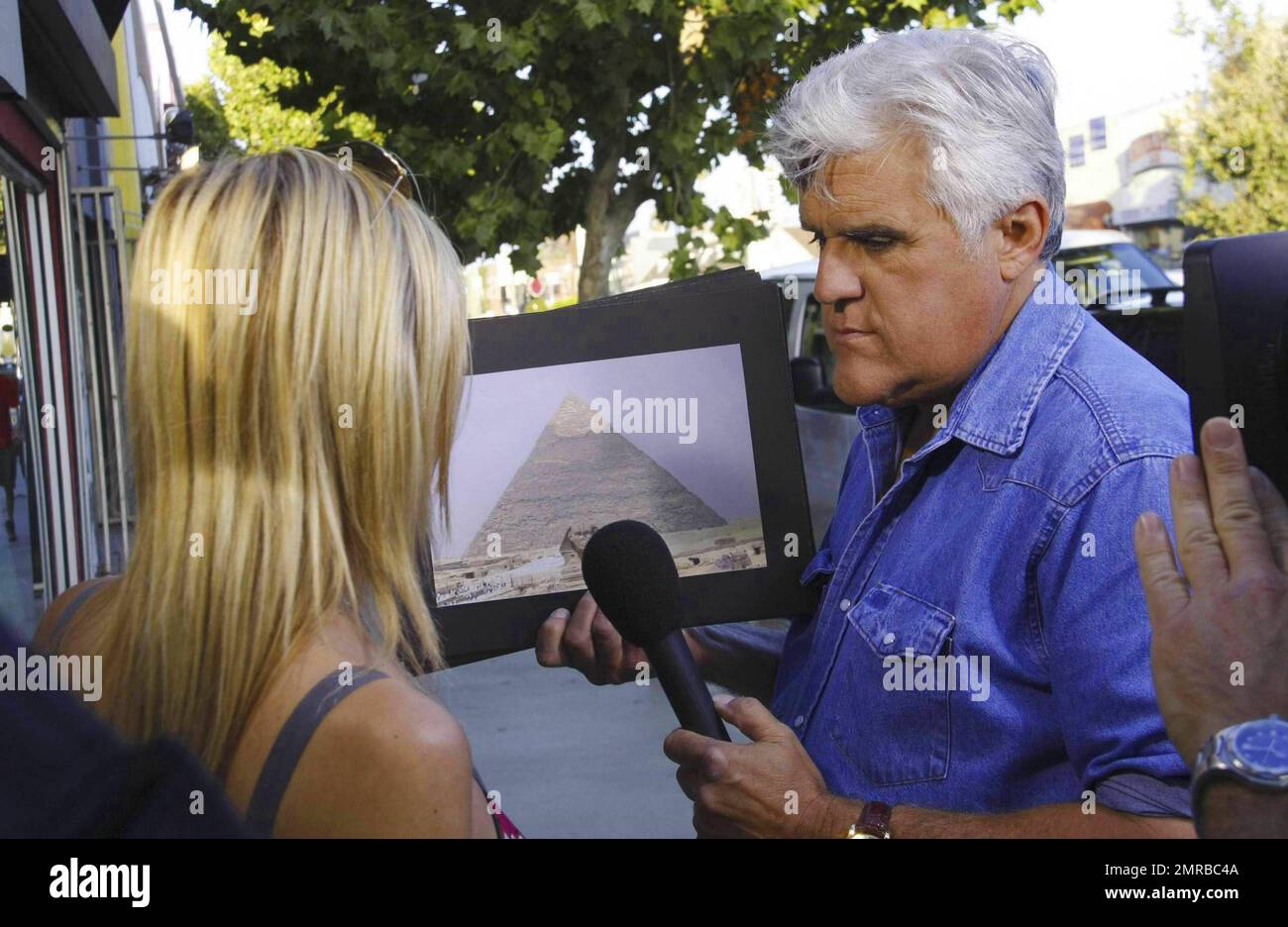 Jay Leno shows a passerby photos of some of the world's most well known ...