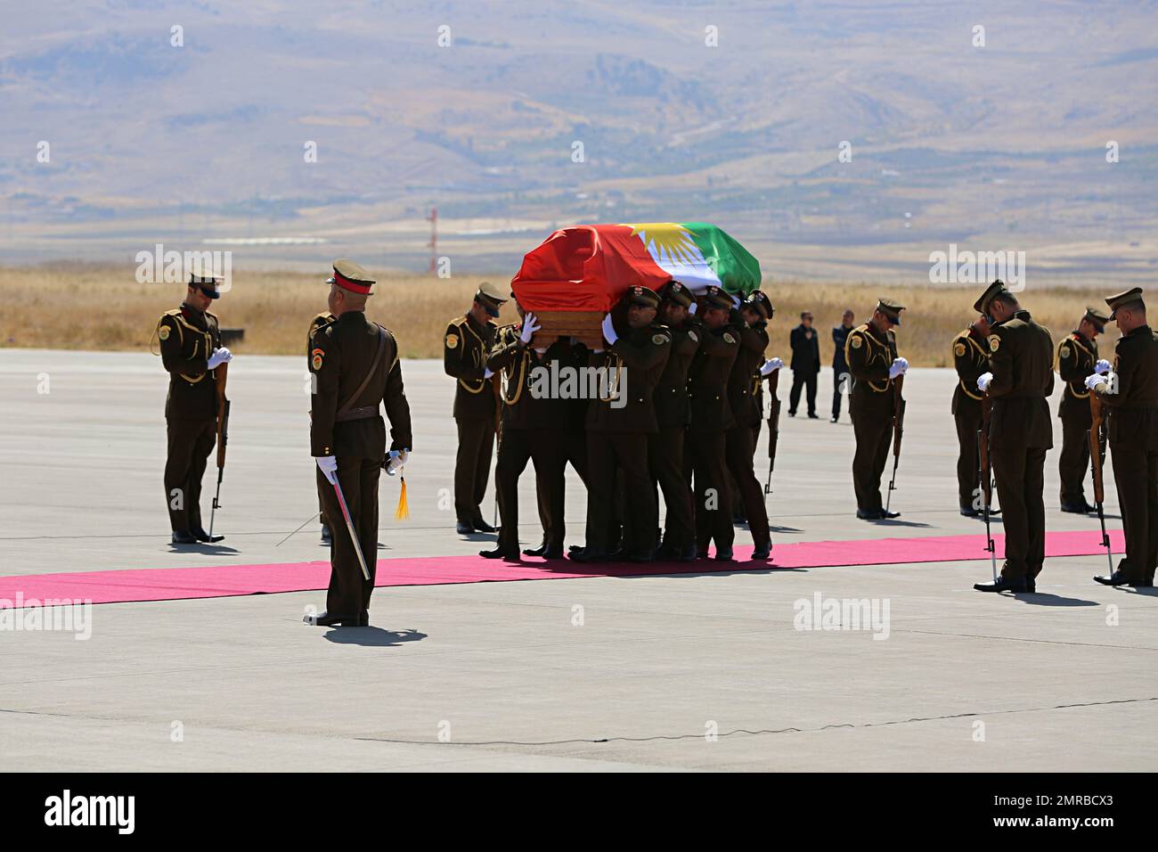 Iraqi Kurdish honour guards carry the Kurdish flag-draped coffin of ...