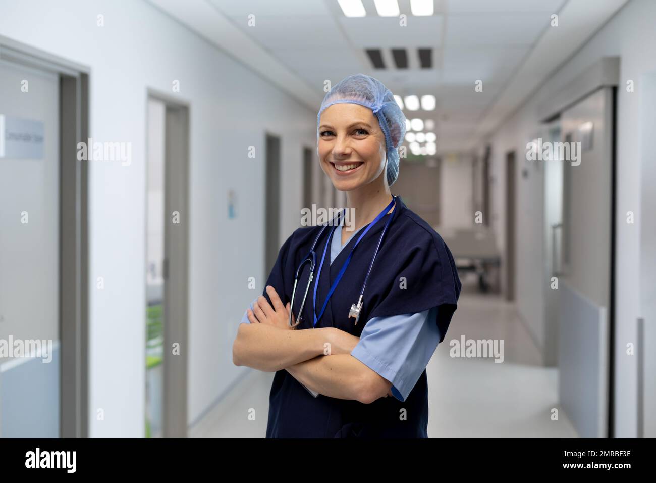 Portrait of happy caucasian female doctor wearing hair net working at ...