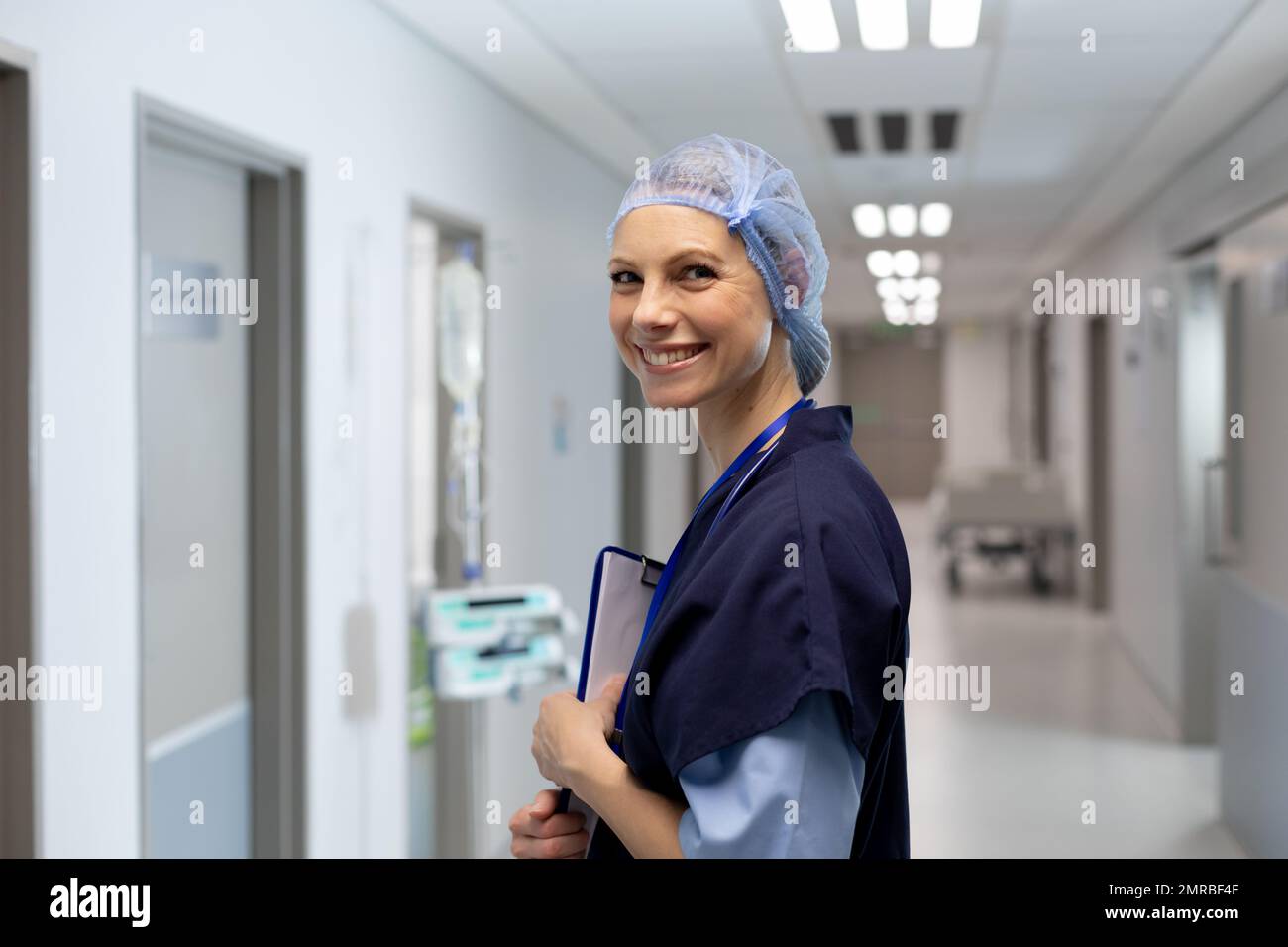 Portrait of smiling caucasian female doctor wearing hair net working at ...
