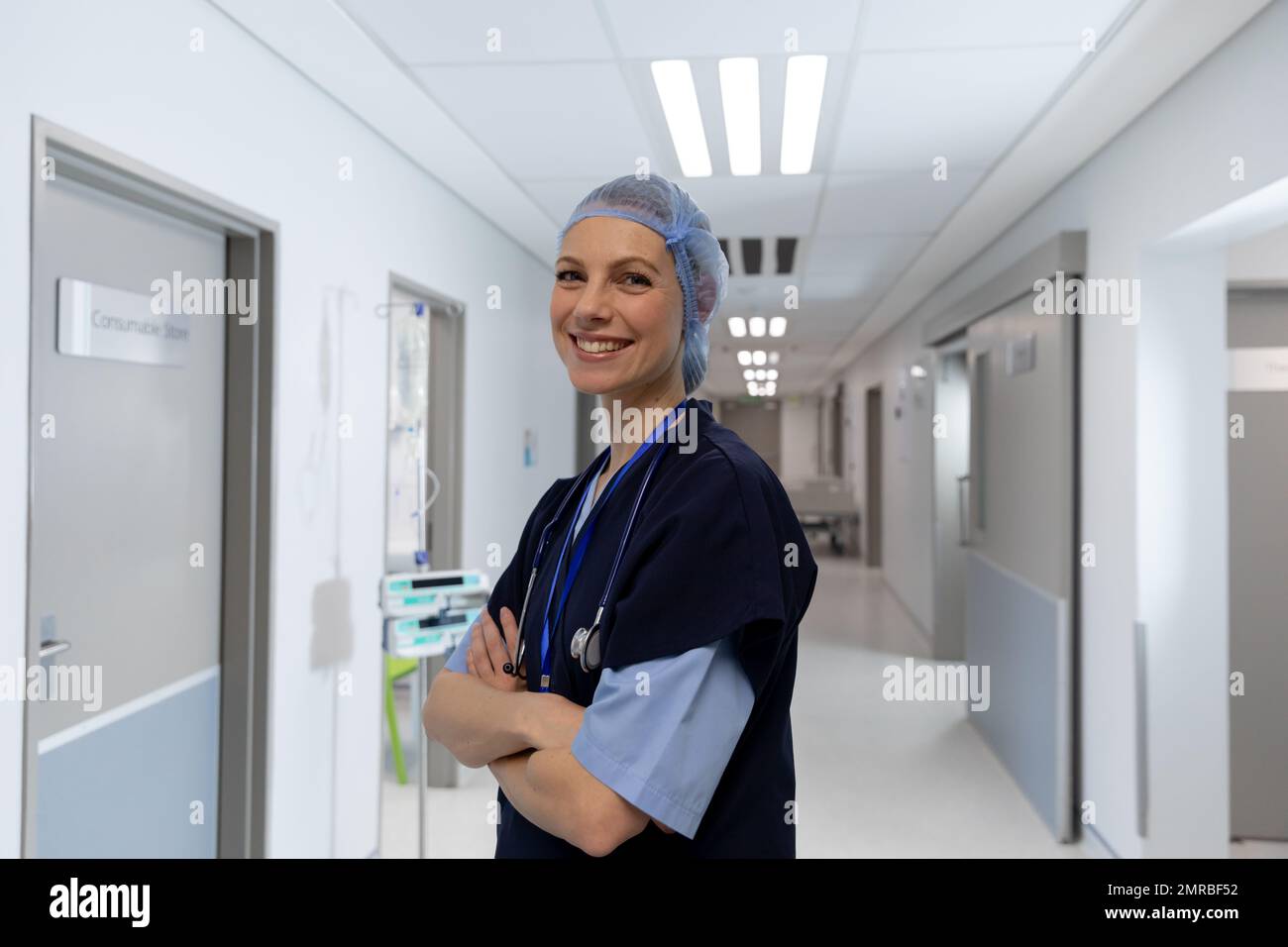 Portrait of smiling caucasian female doctor wearing hair net working at ...