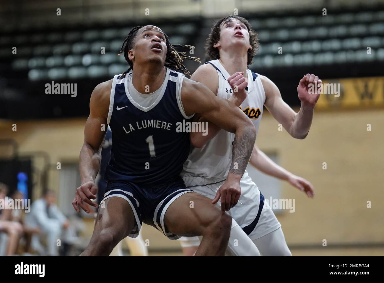 two basketball player holding and defender each other on the court ...