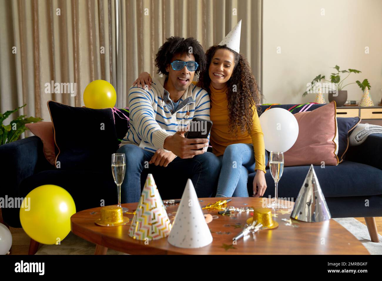 Happy biracial couple having party at home, making celebration video ...
