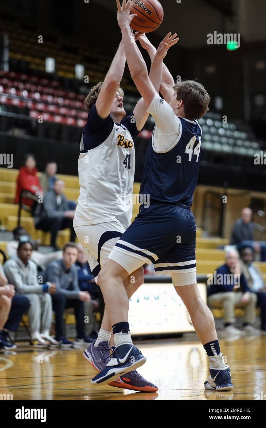A white basketball player shooting the ball against the defender Stock ...