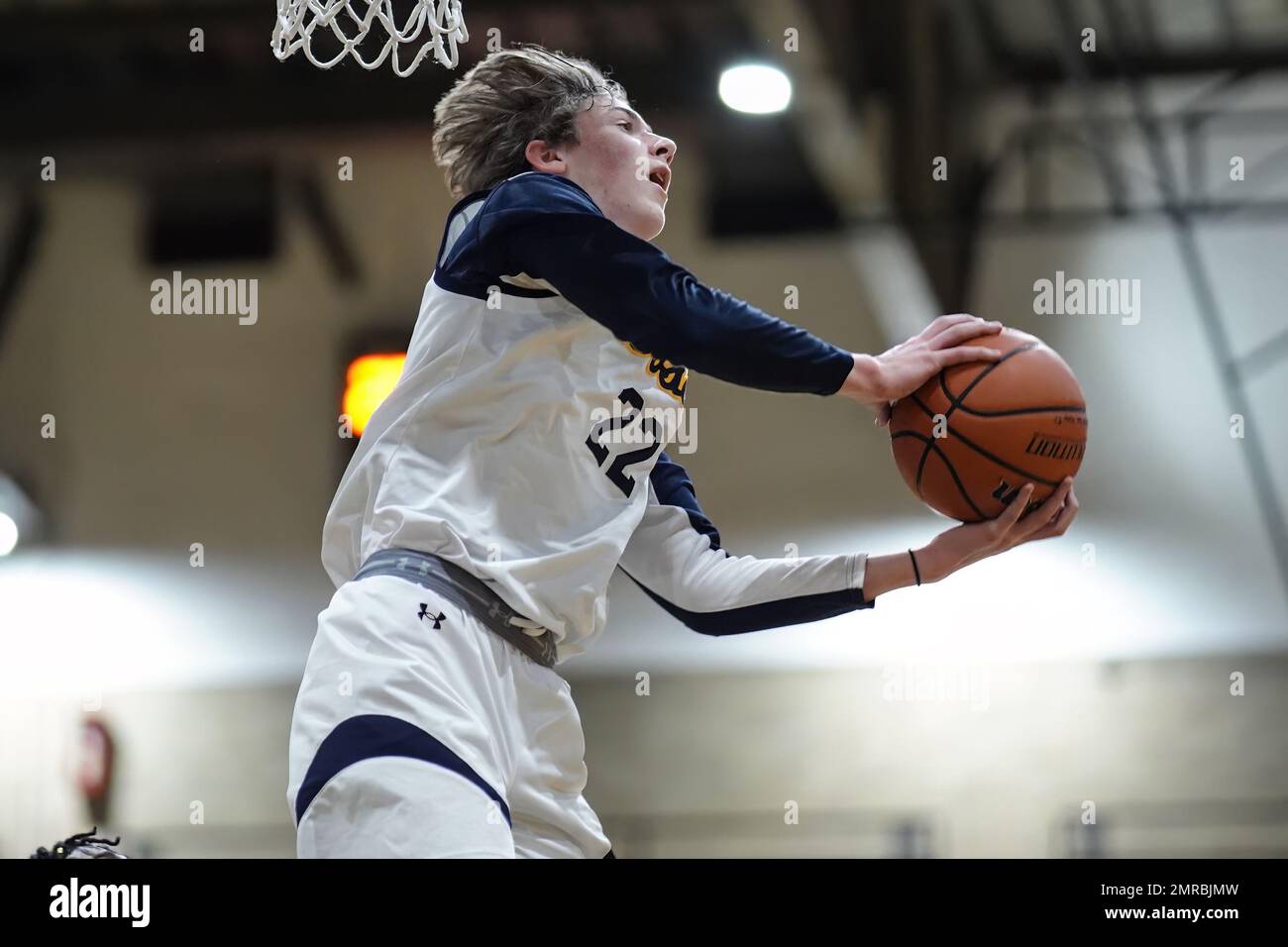 A white basketball player holding the ball against the defender Stock ...
