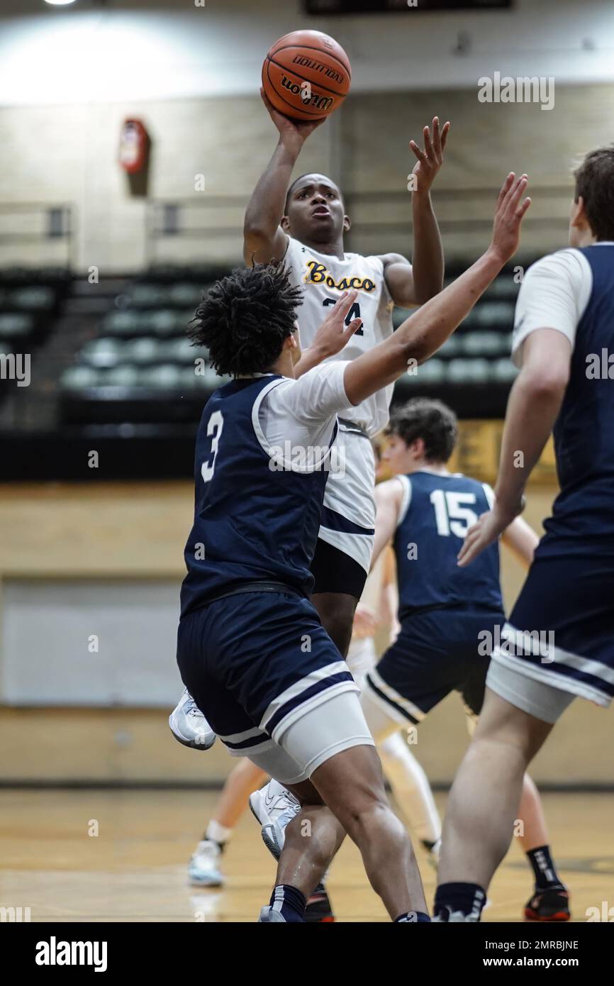 A black basketball player shooting the ball against the defender Stock ...