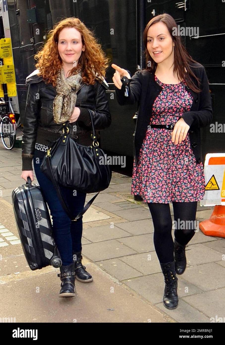 Wearing a black leather jacket, gold scarf and jeans, "Coronation ...