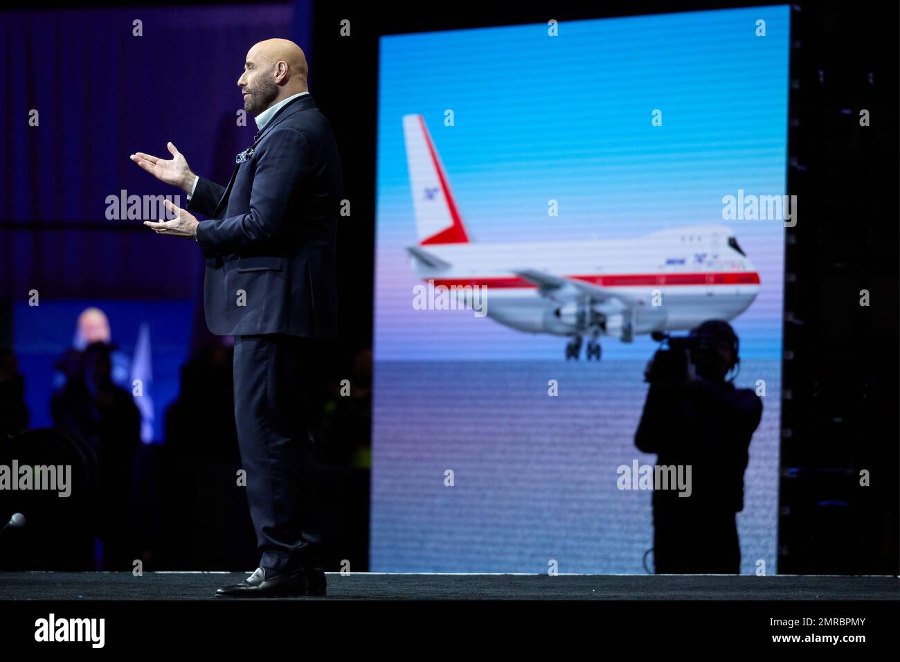 Actor and pilot John Travolta speaks during a ceremony for the delivery ...