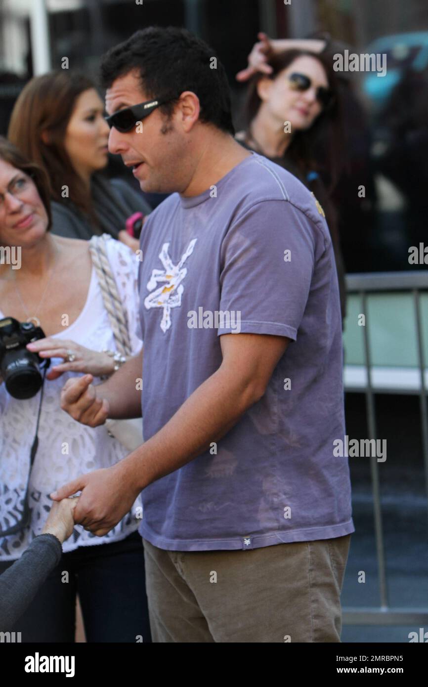 Jennifer Aniston is joined by her boyfriend Justin Theroux, father John ...