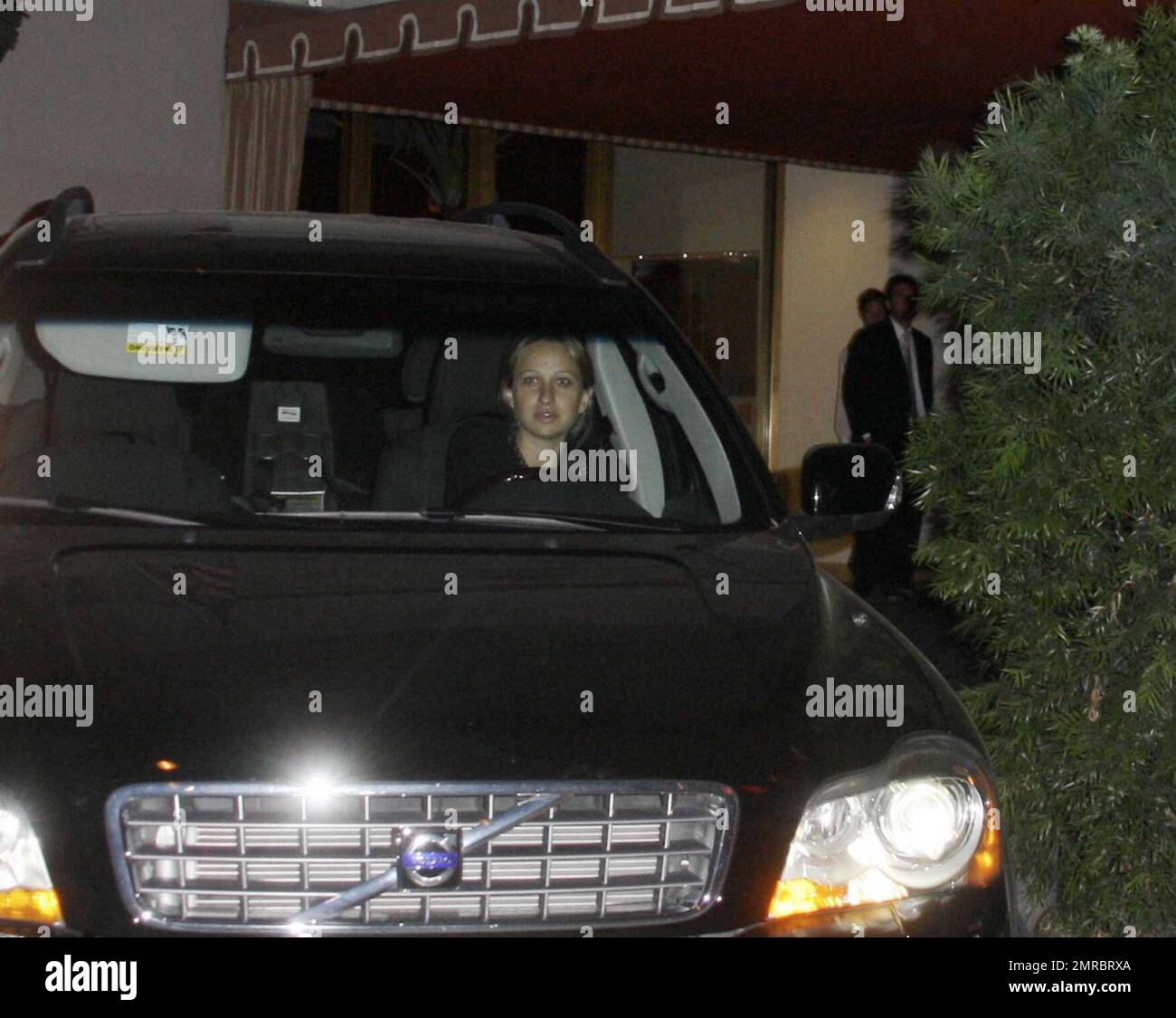 Toby Maguire's wife Jennifer Meyer drives while Toby ducks down to hide ...