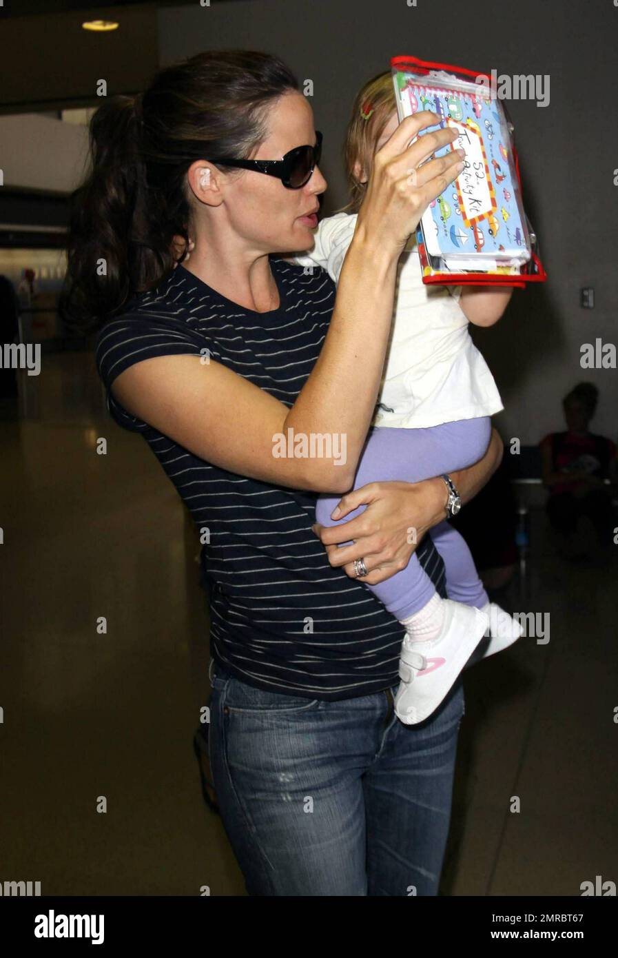 A casually dressed Jennifer Garner arrives at LAX with her daughters ...