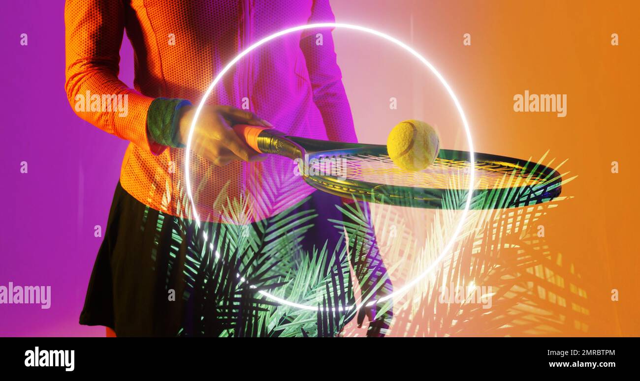 Midsection of biracial female tennis player with racket and ball by ...