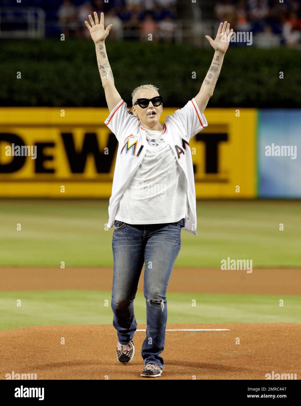 Actress Lori Petty reacts after throwing a ceremonial pitch before a ...