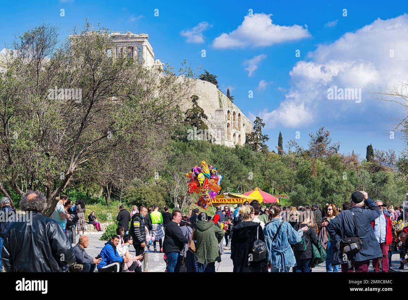 A big crowd of tourists around the Acropolis of Athens Unesco heritage ...