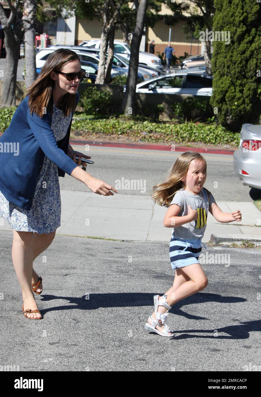 Wearing a blue patterned dress with a blue cardigan and sandals ...