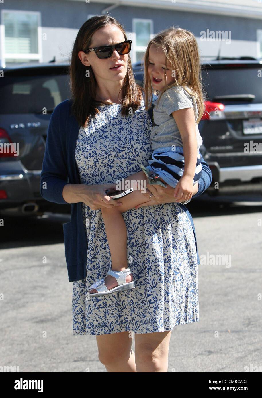 Wearing a blue patterned dress with a blue cardigan and sandals ...