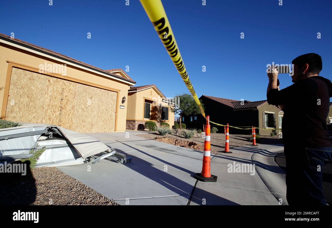 A man takes a photo of the home of Stephen Craig Paddock on Monday, Oct ...