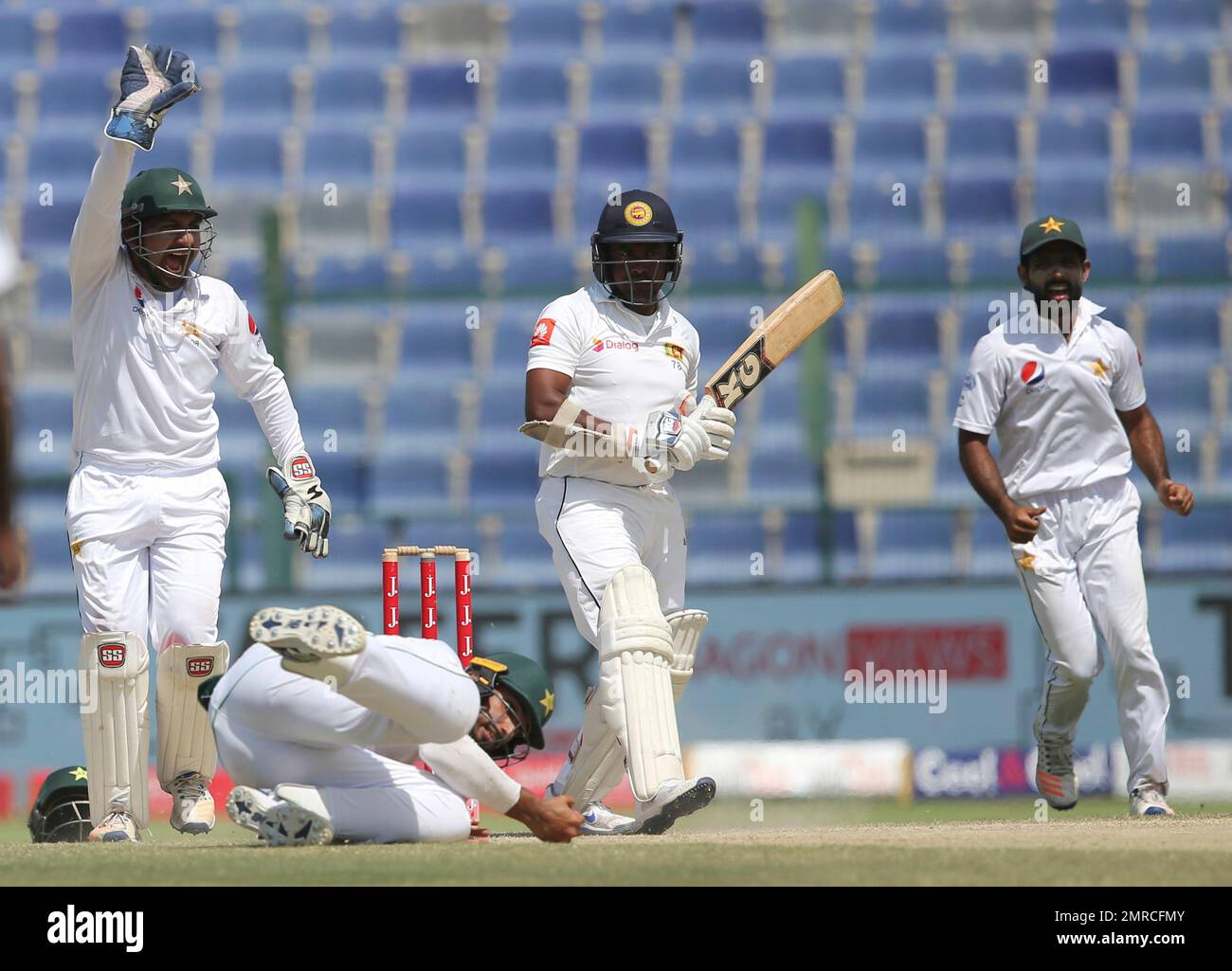 Pakistan's Shan Masood catches the ball as his teammates celebrate the ...