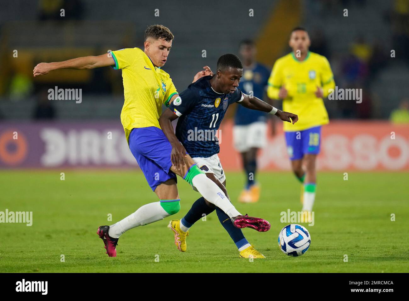 Brazil's Stenio, left, and Ecuador's Alan Minda duel for the ball ...