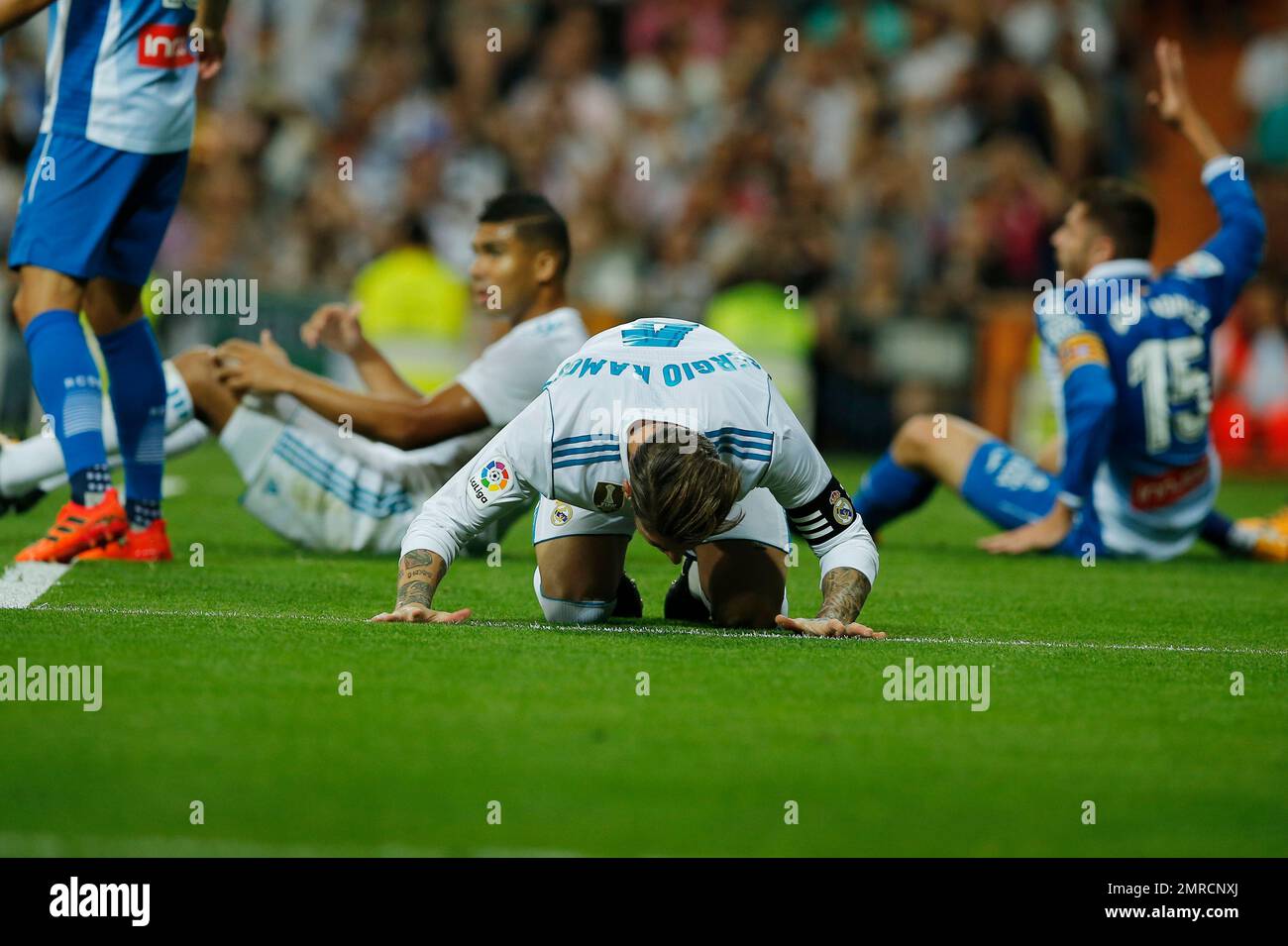 Real Madrid's Sergio Ramos kneels on the pitch as he reacts during a ...
