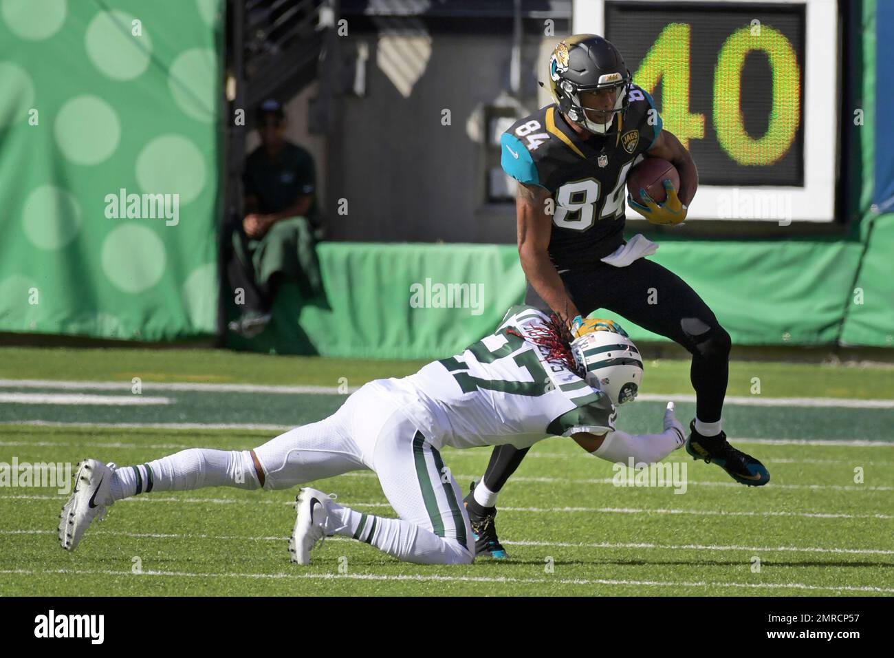 New York Jets' Darryl Roberts, left, tackles Jacksonville Jaguars ...