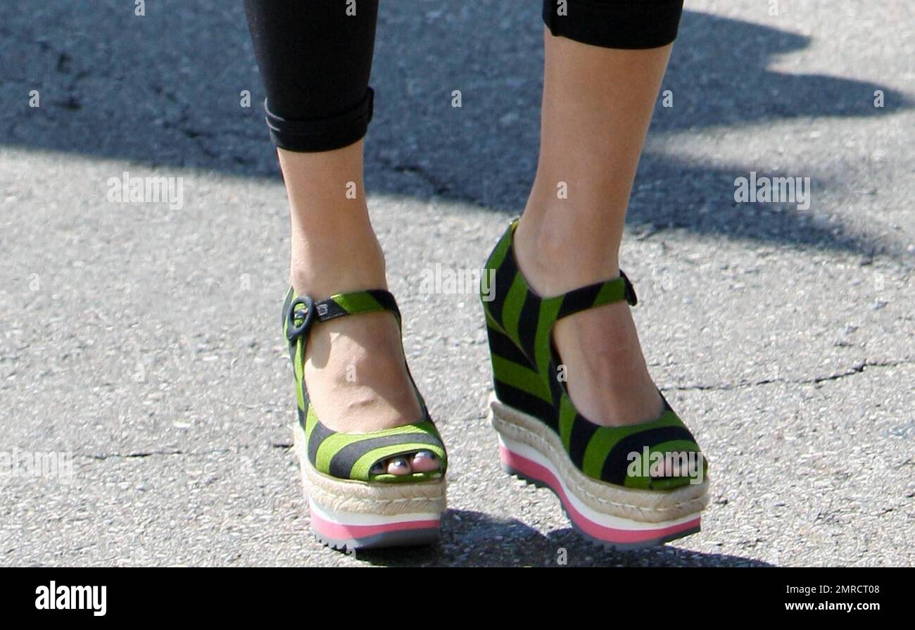 Jessica Alba wears a black dress and black leggings with some funky ...