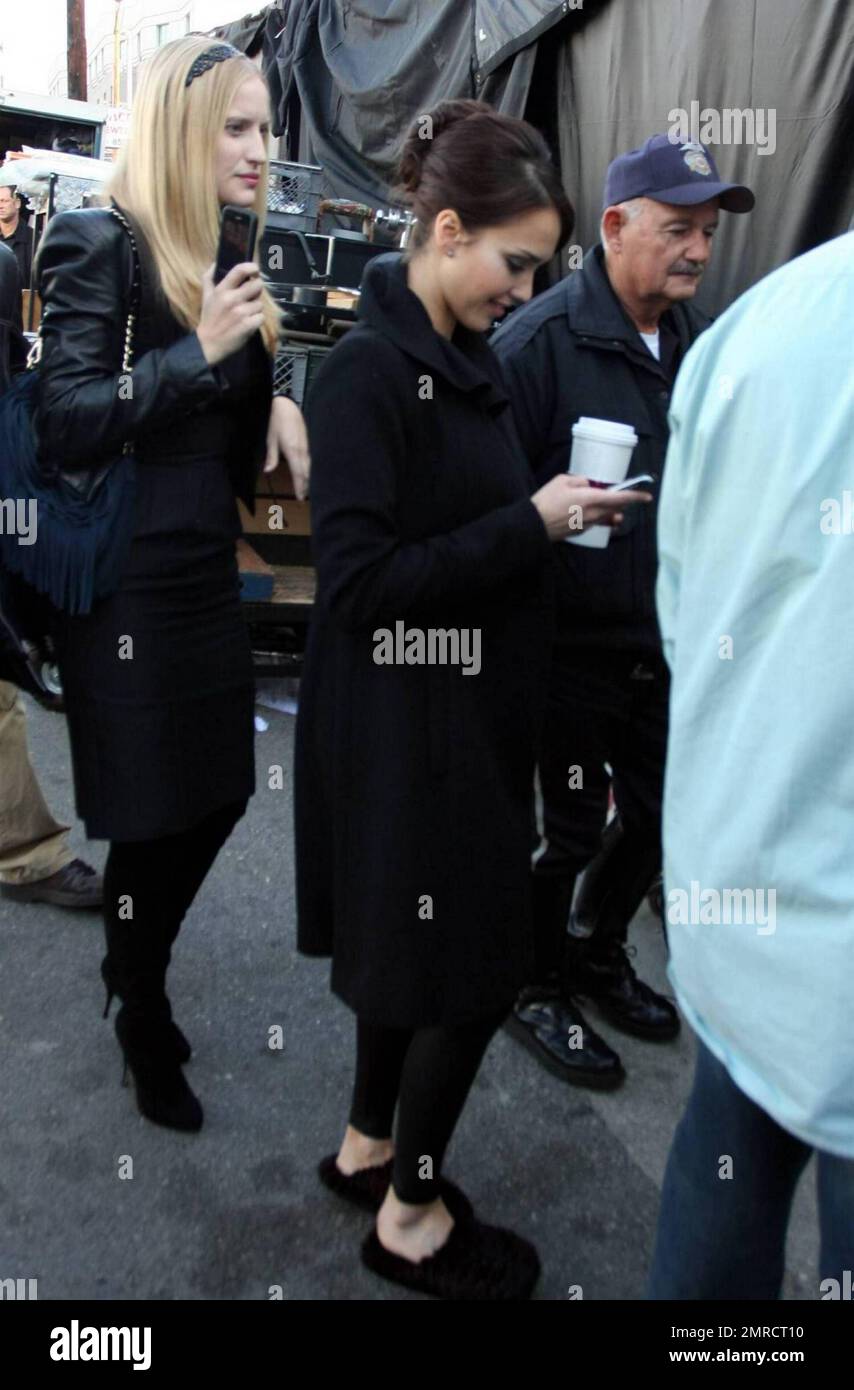 Jessica Alba looks comfy in a pair of fuzzy slippers while checking her ...