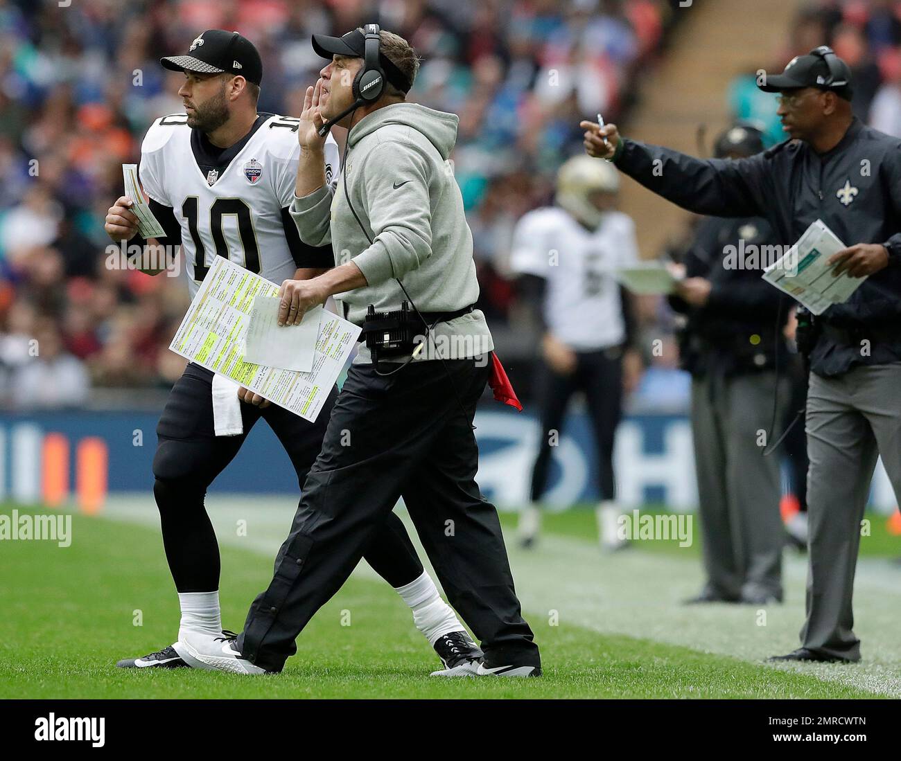 New Orleans Saints head coach Sean Payton, center, shouts out ...