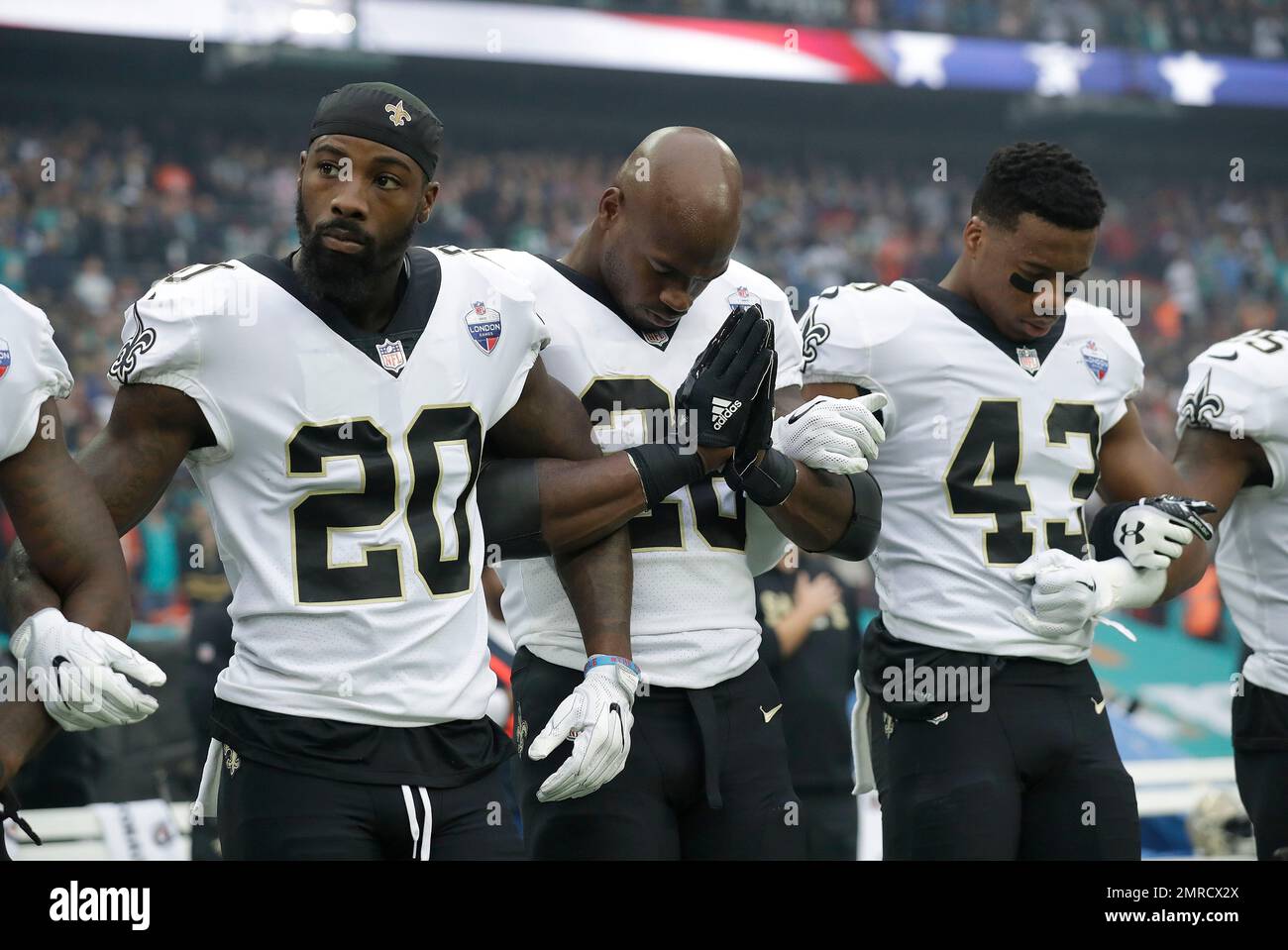 New Orleans Saints running back Adrian Peterson, center, prays as he ...