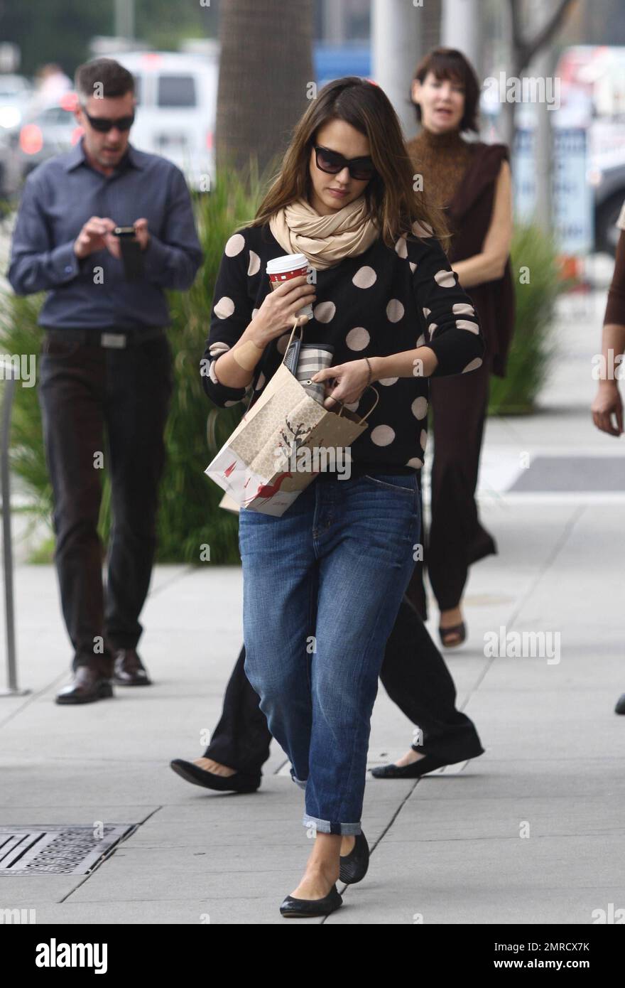 Jessica Alba keeps her head down, but smiles slyly after a visit to ...