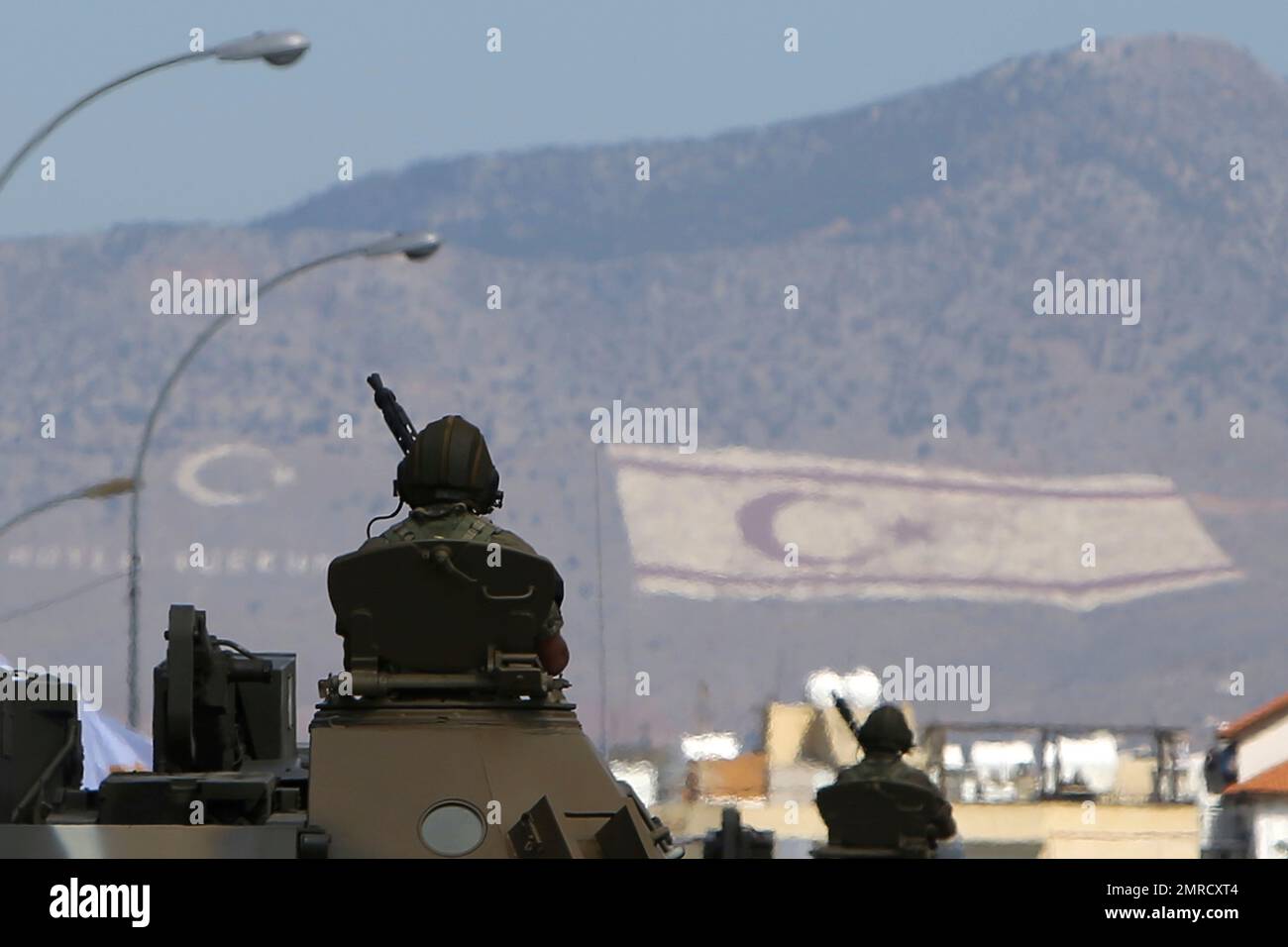 Cypriot soldiers are seen on armored vehicles during a military parade ...