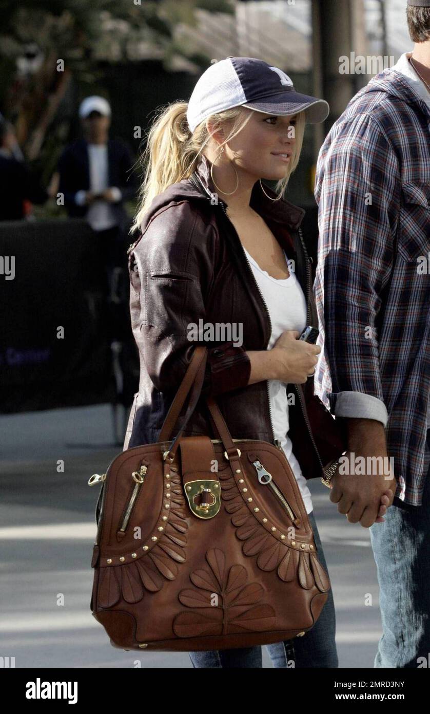 Jessica Simpson covers up her long blonde locks with a baseball cap as ...