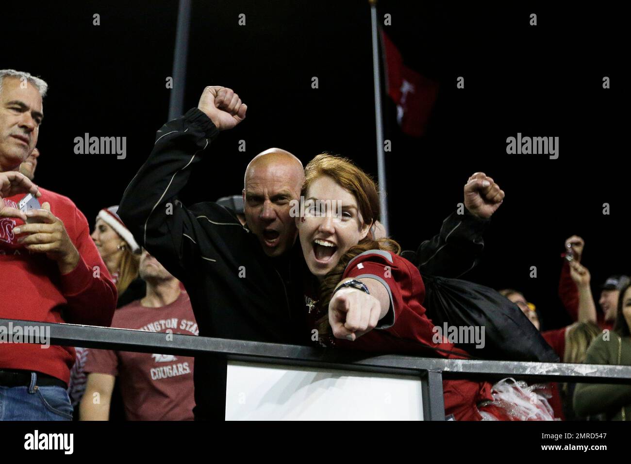 Fans cheer for a photograph during the second half of an NCAA college ...