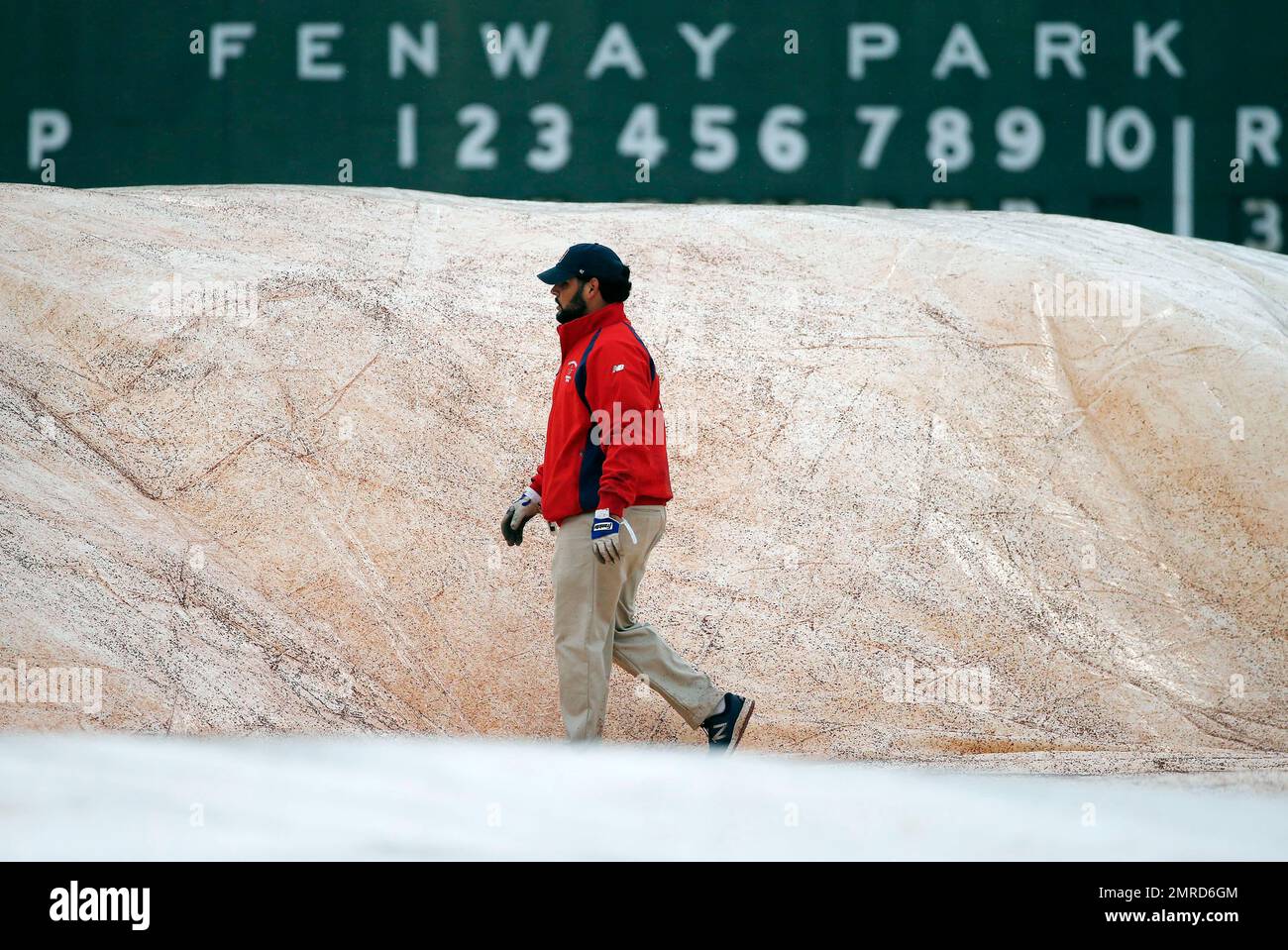 The Fenway Park grounds crew removes the tarp before a baseball game ...